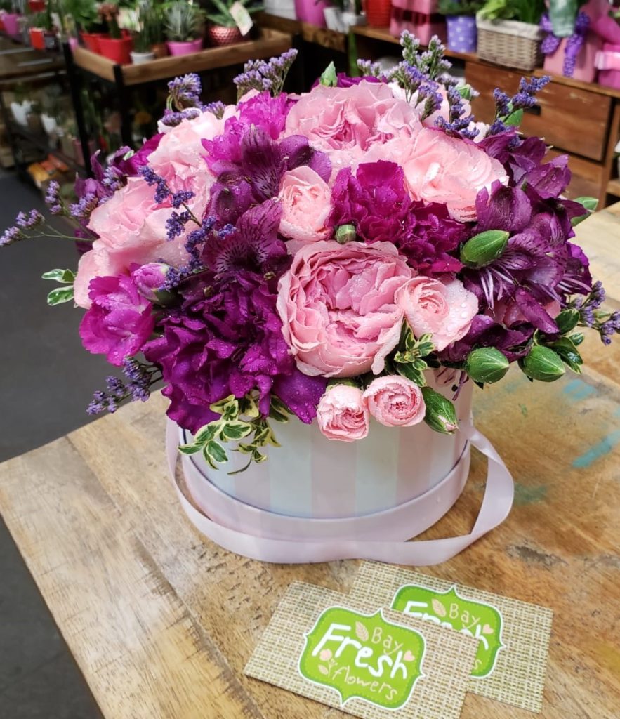 Pretty violet - Flower arrangement in a hat box.